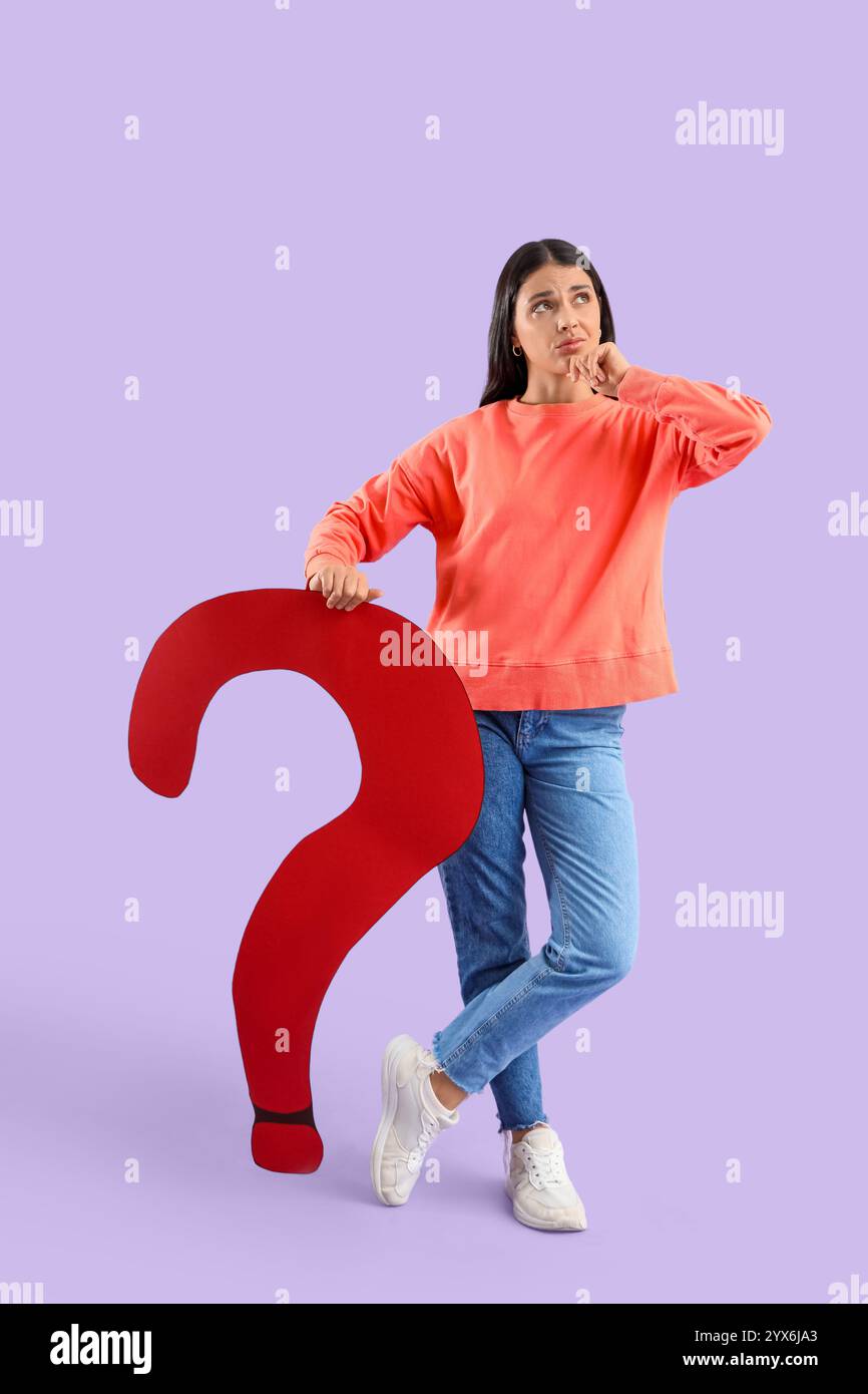 Young woman with big paper question mark on lilac background Stock ...