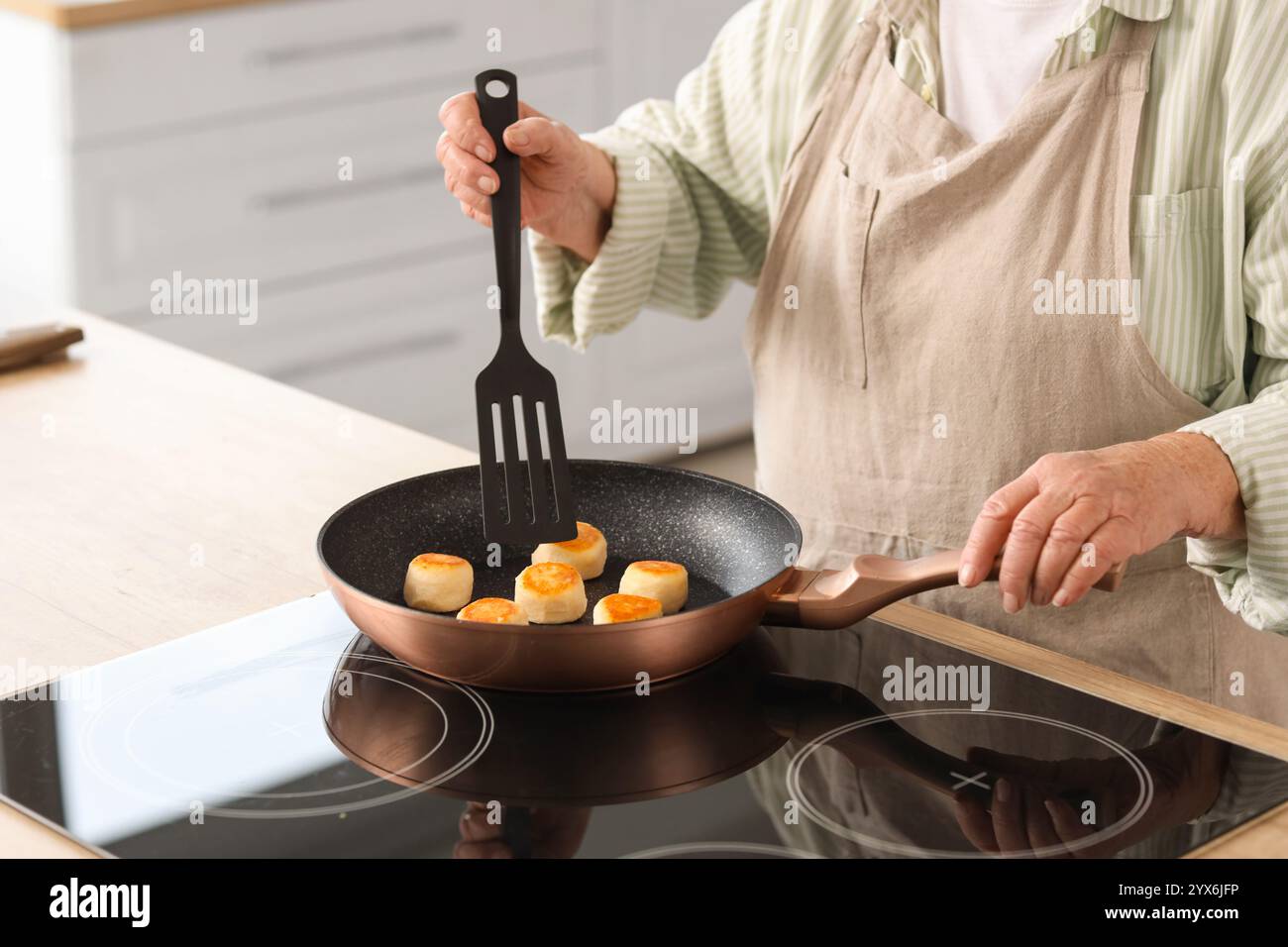 Senior woman frying cottage hi-res stock photography and images - Alamy
