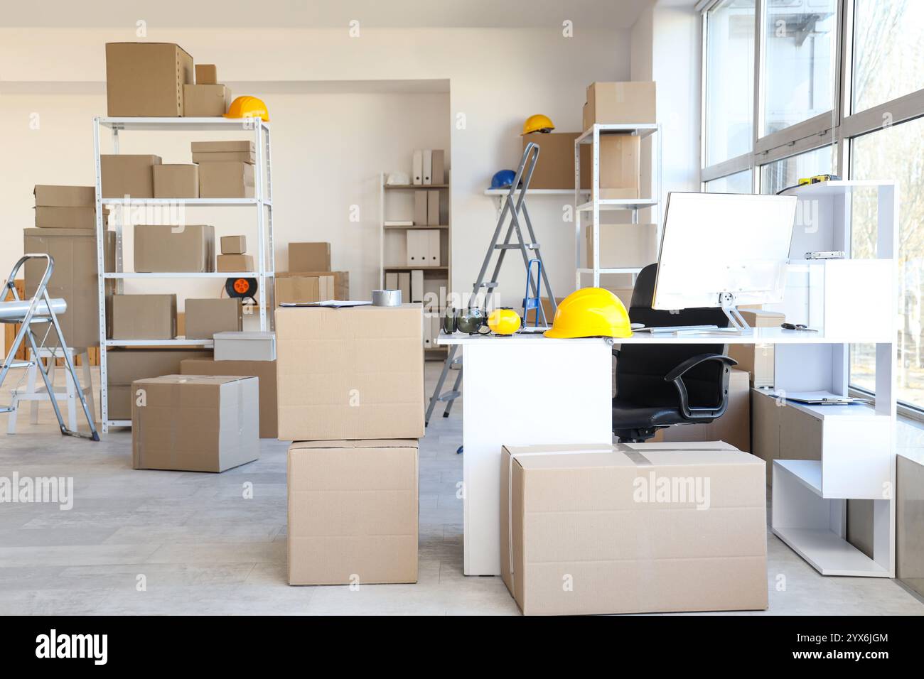 Interior of warehouse with shelf units, cardboard boxes and table Stock ...