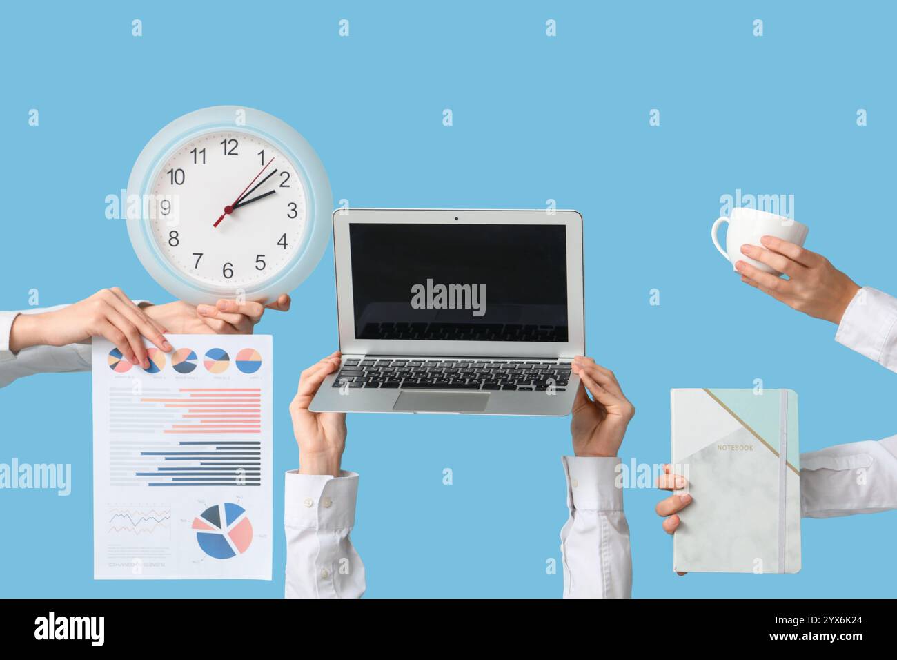 Female hands with blank laptop, clock, diagrams and notebook on blue ...