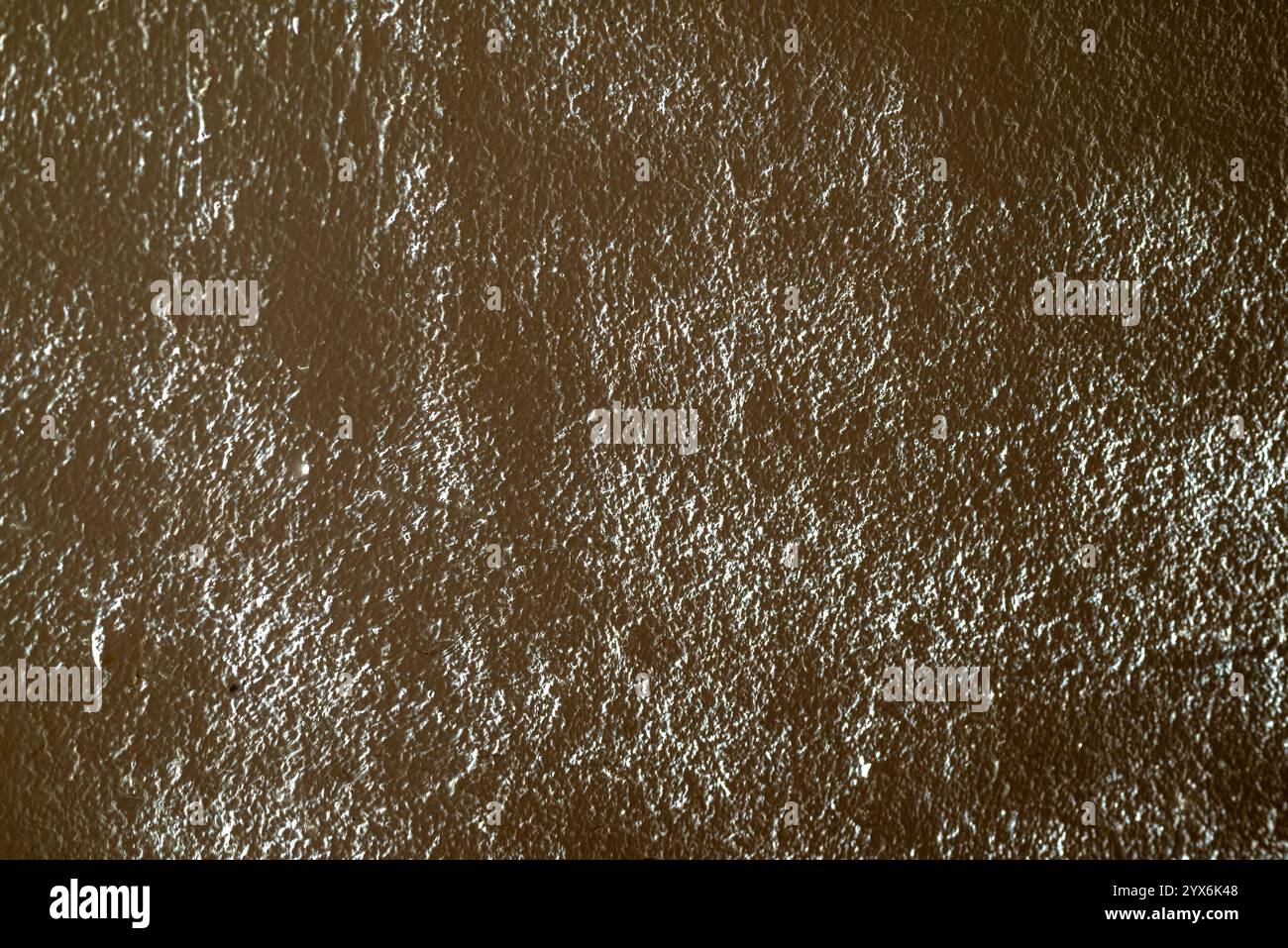 the rough texture of plaster illuminated by the warm rays of the ...