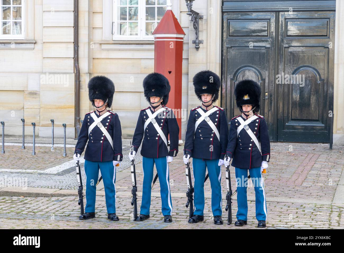 Male and female members of the Royal Guard on duty at Amalienborg ...