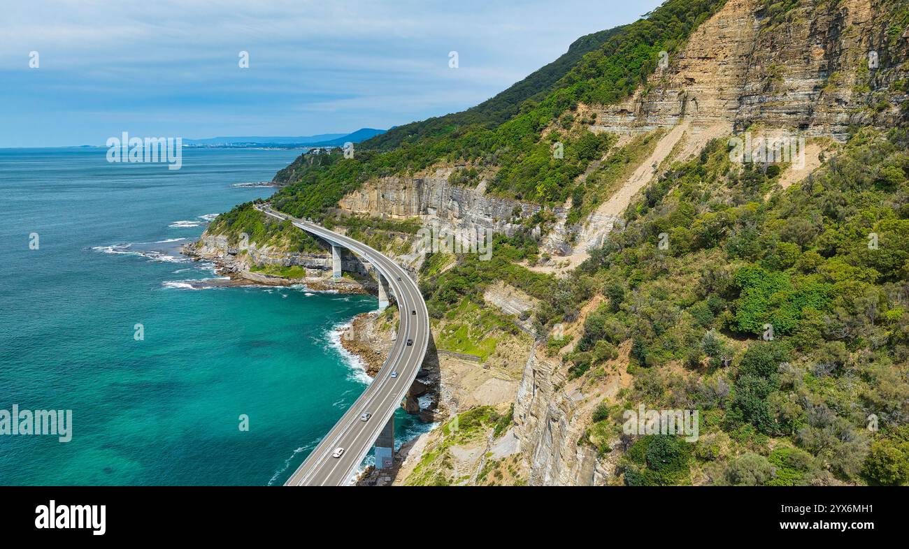 Aerial view of Sea Cliff Bridge curving along the Australian coastline ...