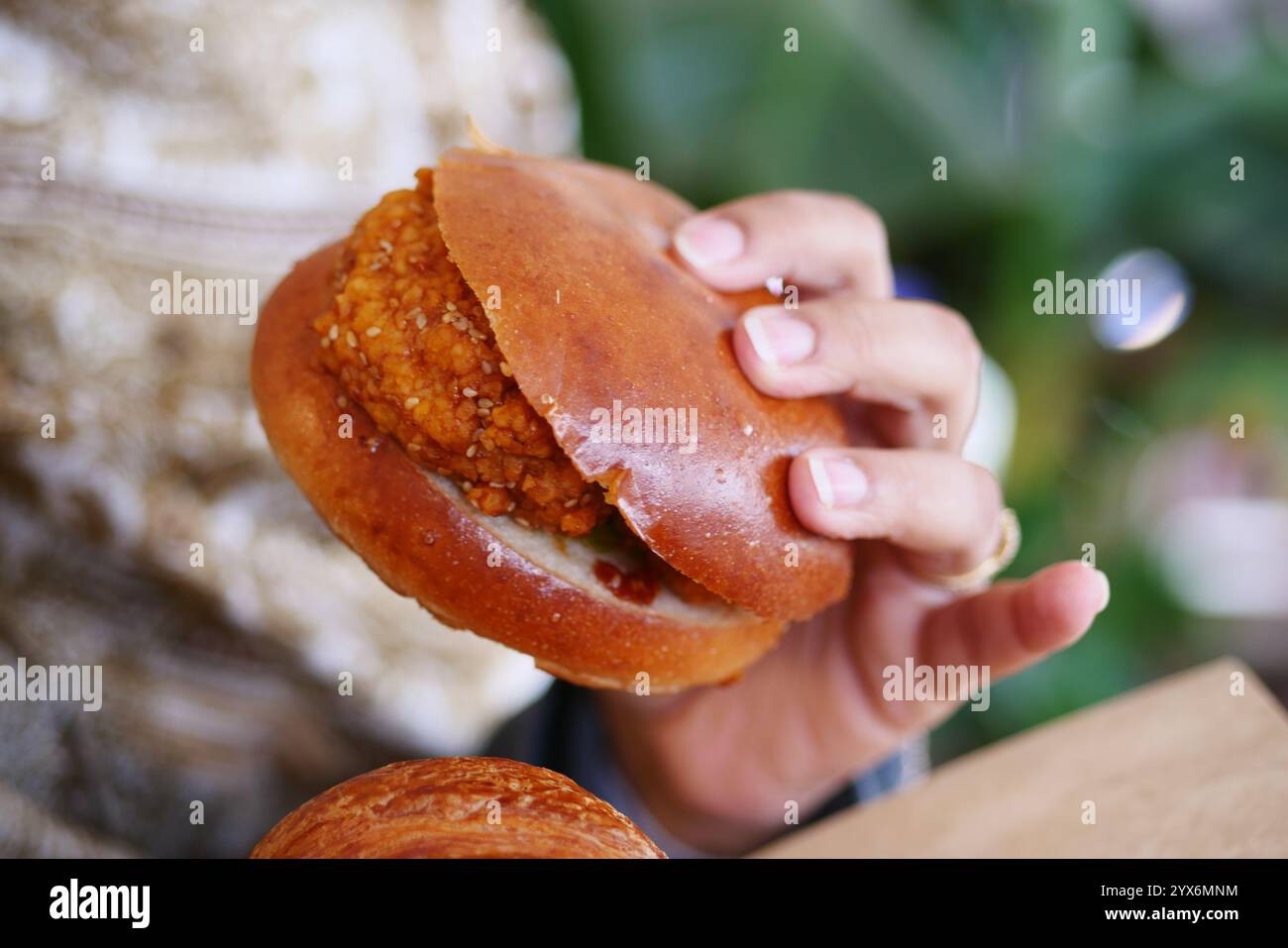 I have a Crispy Chicken Burger in my hand, ready and eager to enjoy it ...