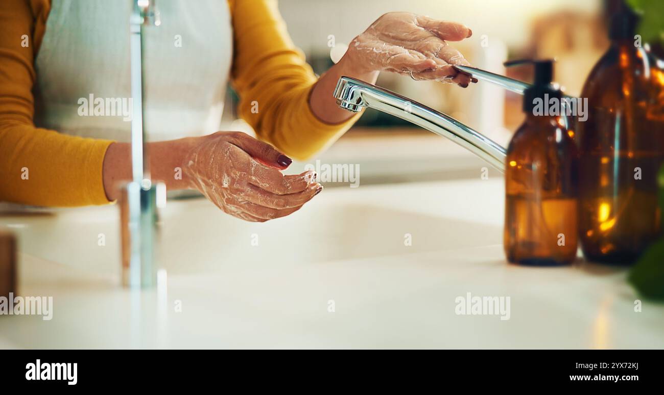 Hands, washing and woman at sink in kitchen with soap product, hygiene ...