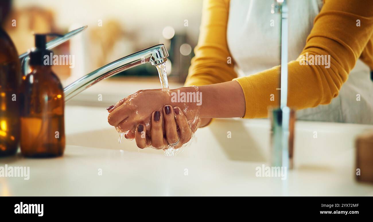 Hands, washing and woman in kitchen with water, soap product and ...
