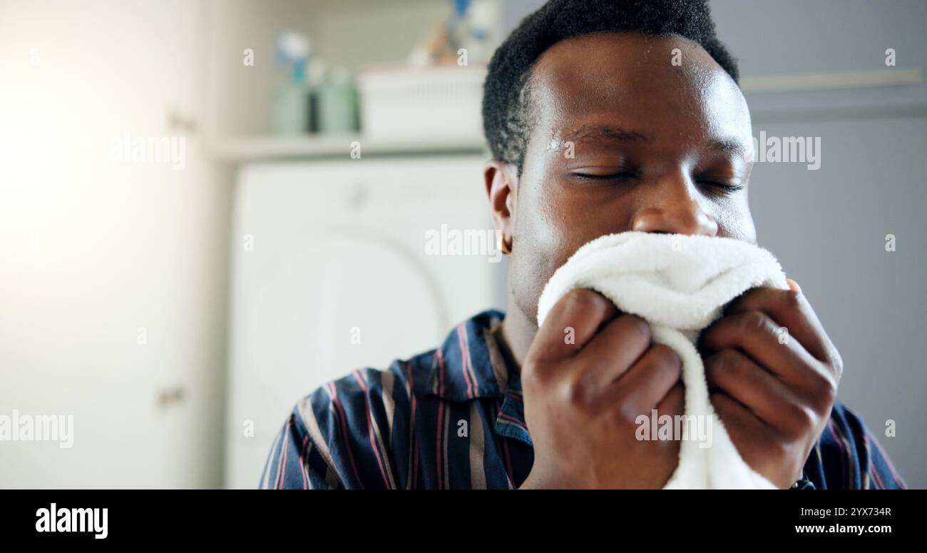Laundry, black man and smell in home for clean blanket, fresh scent and ...