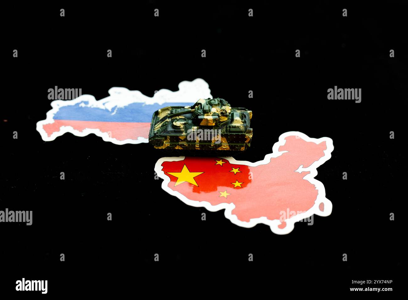Miniature toy tank on maps of Russia and China with Flags colors and ...
