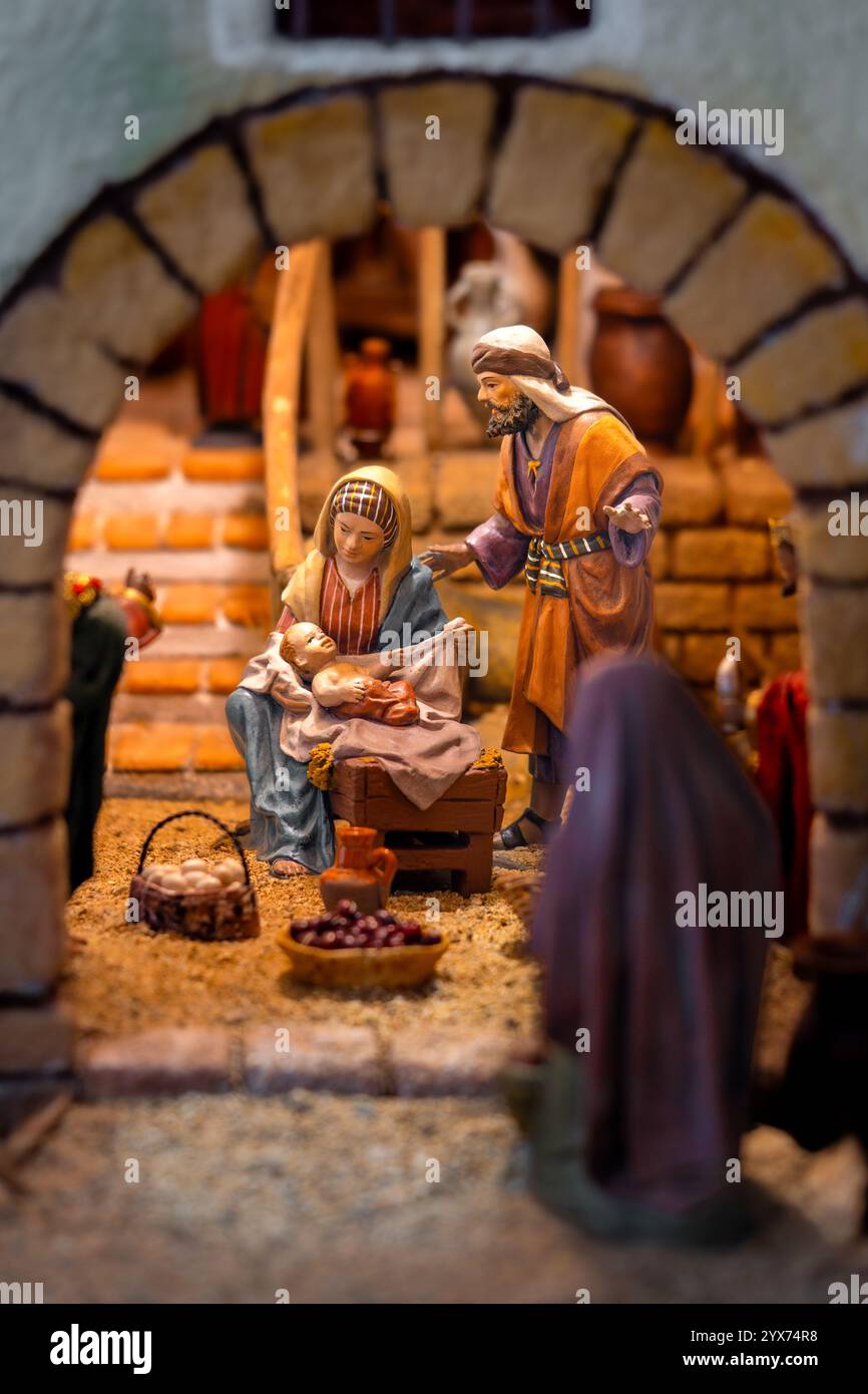 Nativity scene with figures of Mary, Joseph and baby Jesus in a rustic ...