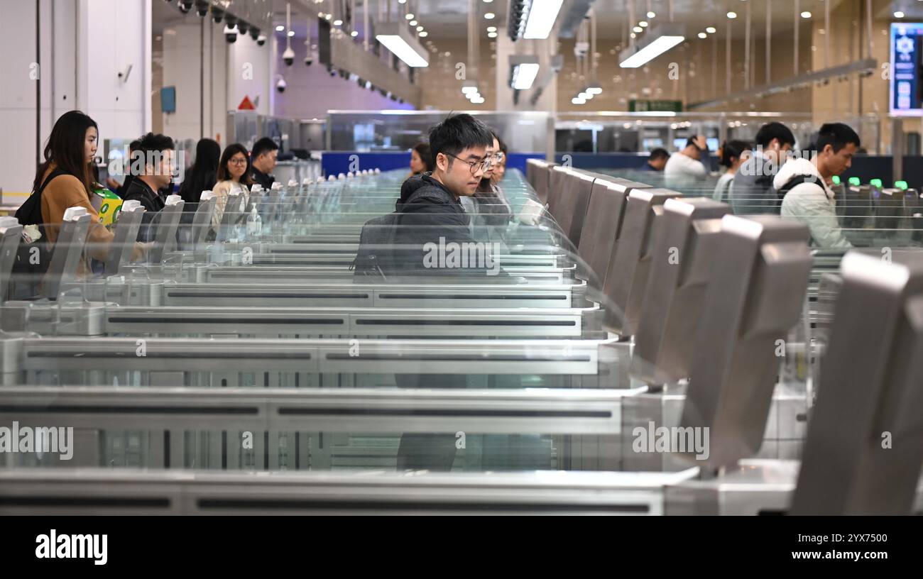 Macao, China's Guangdong Province. 25th Nov, 2024. Passengers pass ...