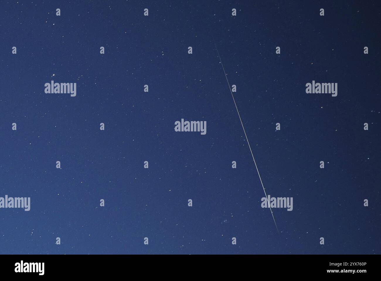 A shooting star lights up the night sky over the suburbs of Beijing in ...