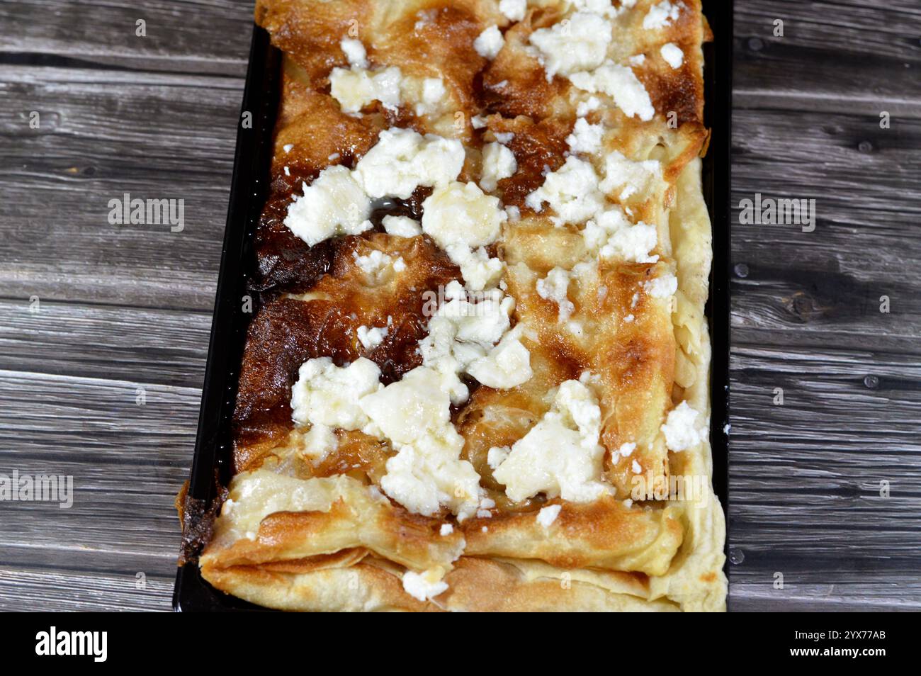 Creamy qeshta or fresh milk cream on a a cushioned pie or Feteer ...