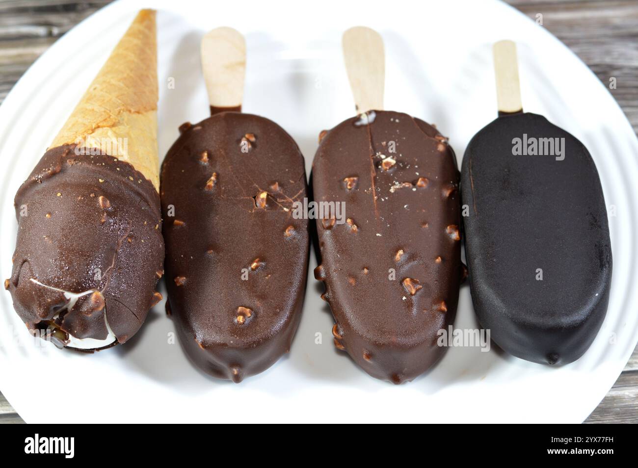 Assorted Ice creams, vanilla cone coated with chocolate layer and nuts ...