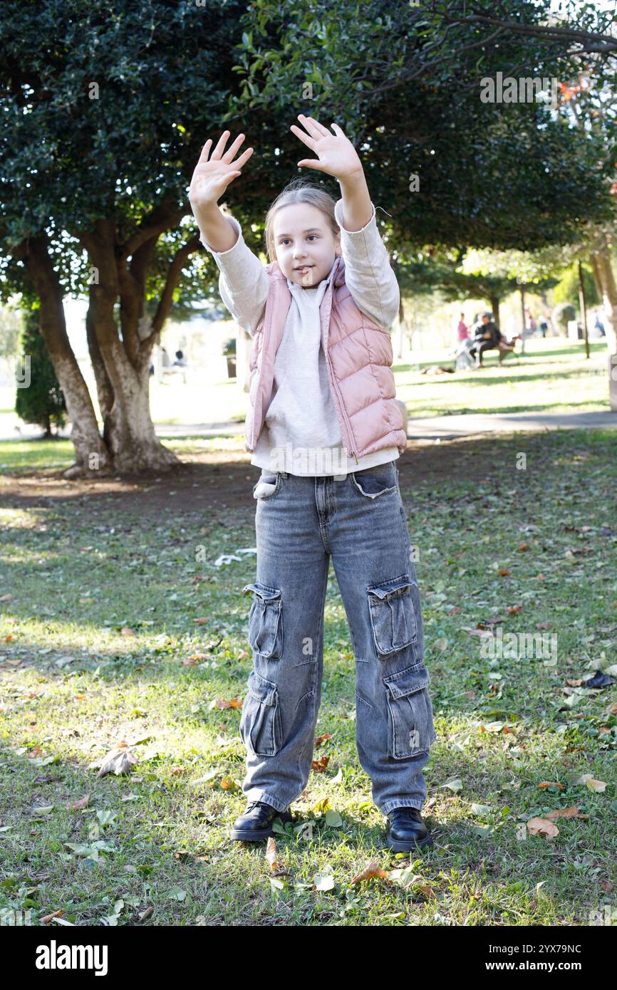 Active child girl catching flying disc in park. Happiness and childhood ...