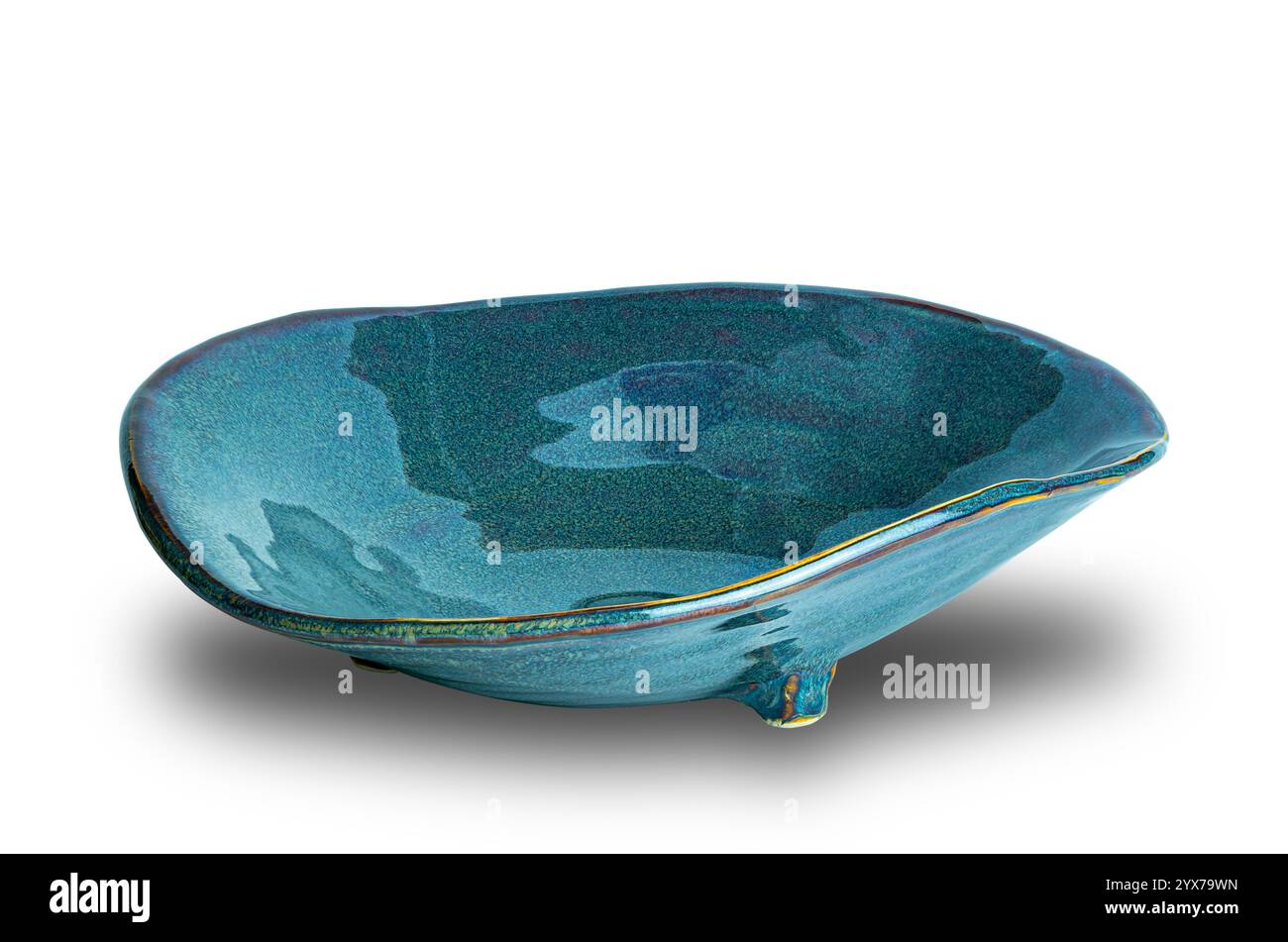 High angle view of single blue deformed ceramic plate with three legs ...