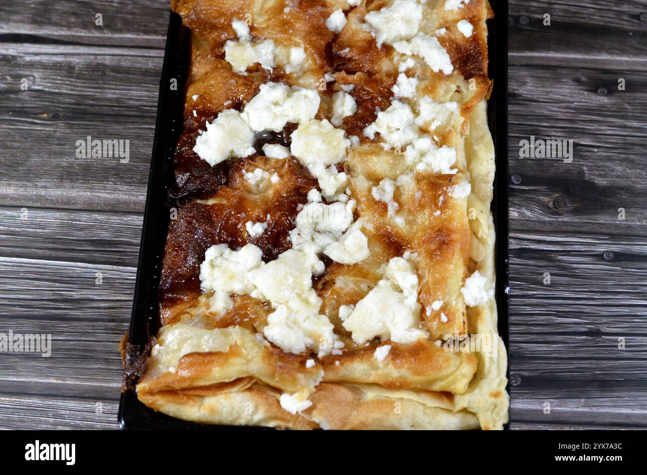 Creamy qeshta or fresh milk cream on a a cushioned pie or Feteer ...