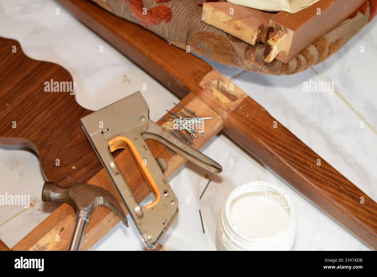 Maintenance of a broken table wood chair to apply wood white glue and ...