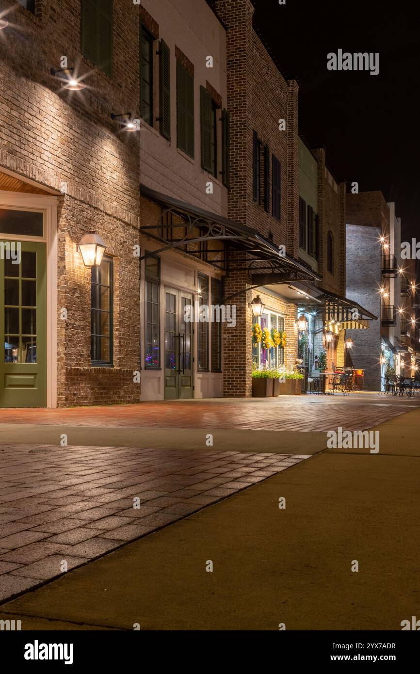 Brick storefronts with street lights at night Stock Photo - Alamy