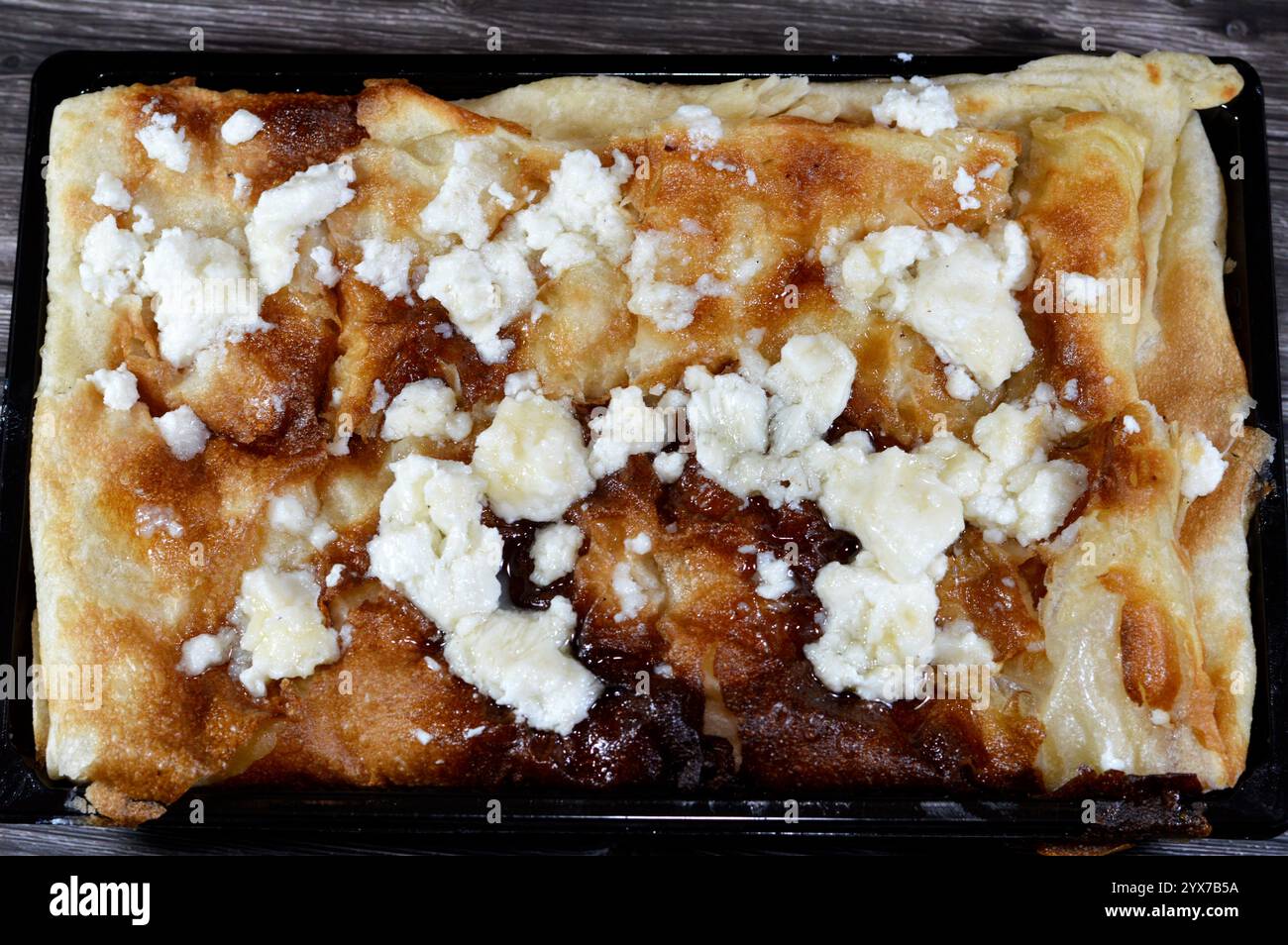 Creamy qeshta or fresh milk cream on a a cushioned pie or Feteer ...