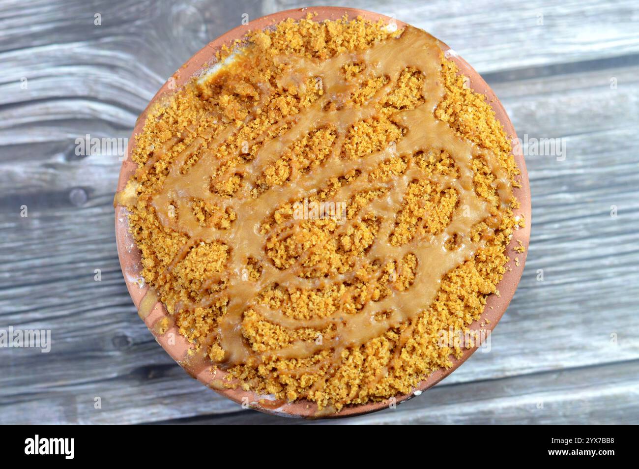 Egyptian bread pudding topped with biscuits butter spread, milk in bowl ...