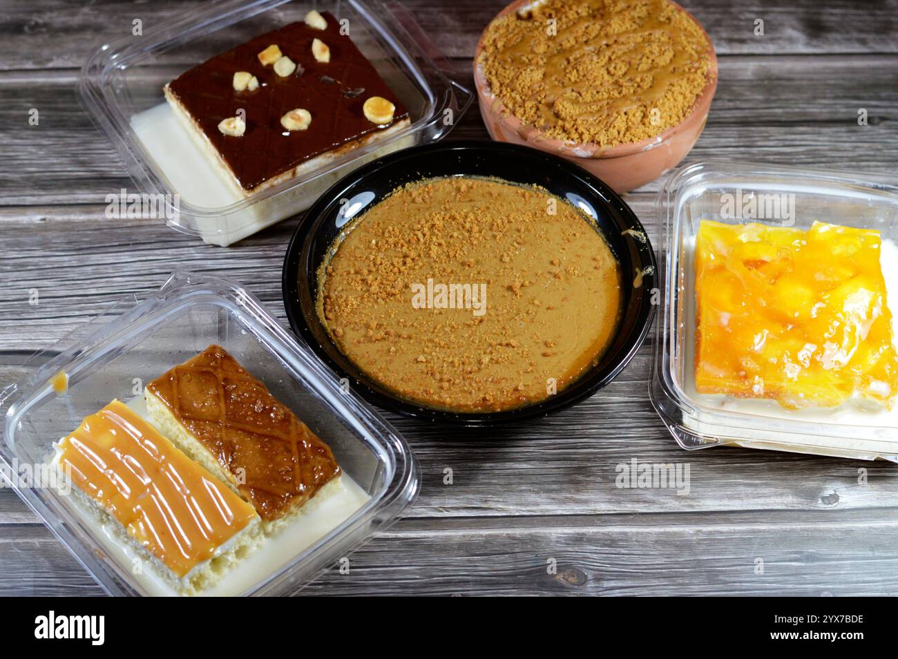 Assorted desserts of Baked Om Ali and rice pudding with milk and sugar topped with biscuits ...
