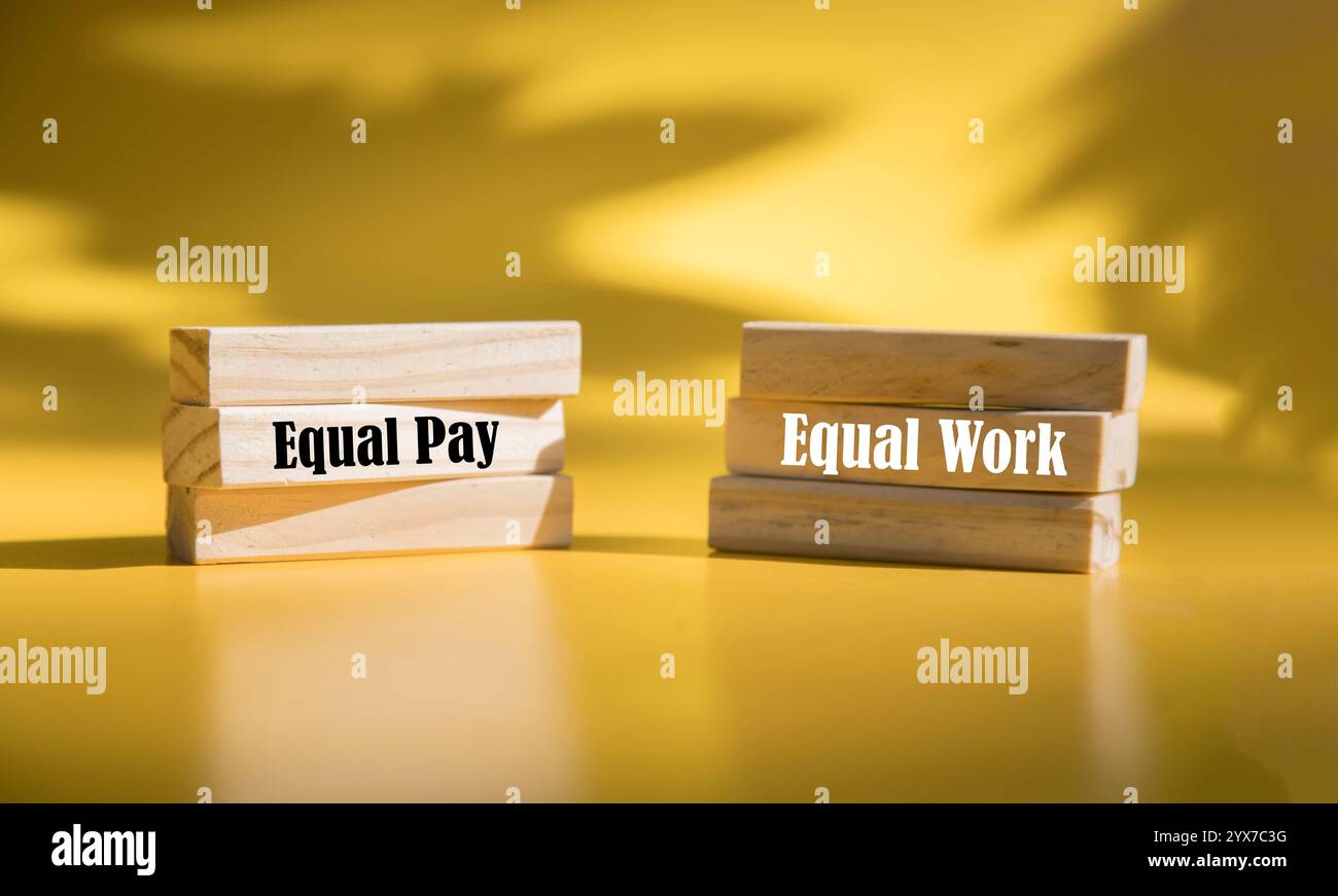 Equal pay and work symbol written wooden blocks Beautiful yellow ...