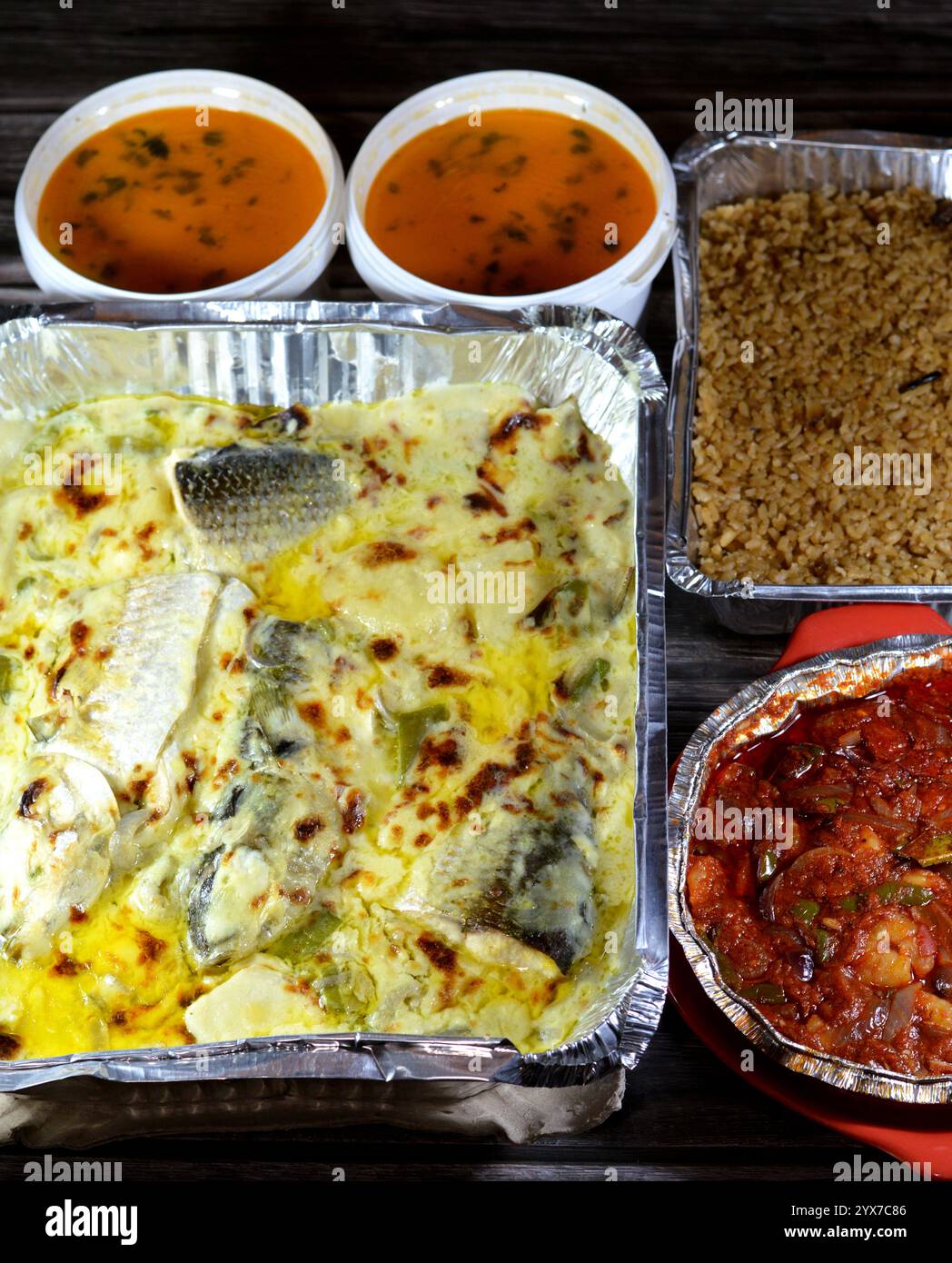 Seafood meal of baked mullet fishes with creamy white sauce, pieces of ...