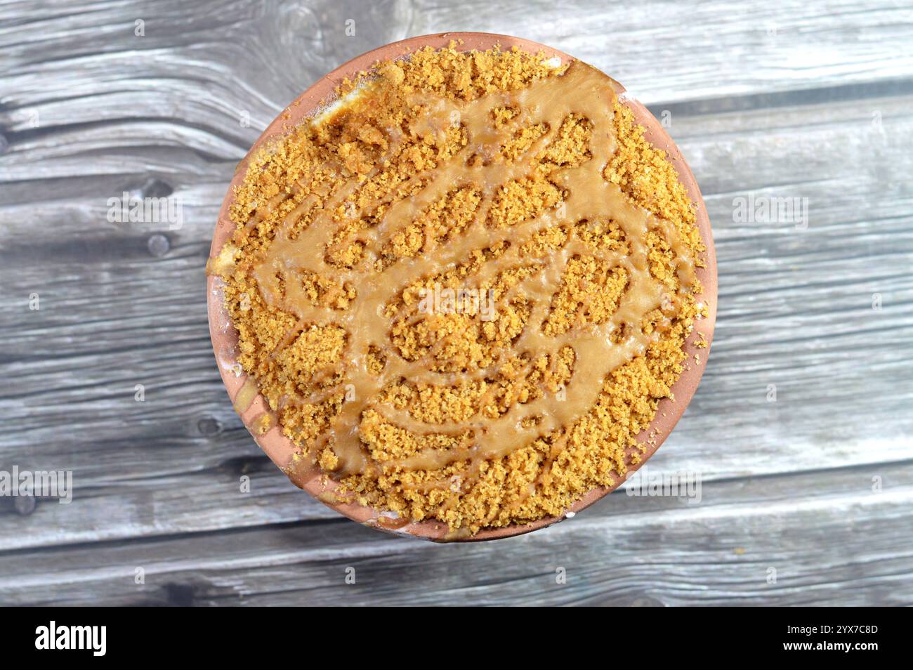 Egyptian bread pudding topped with biscuits butter spread, milk in bowl ...