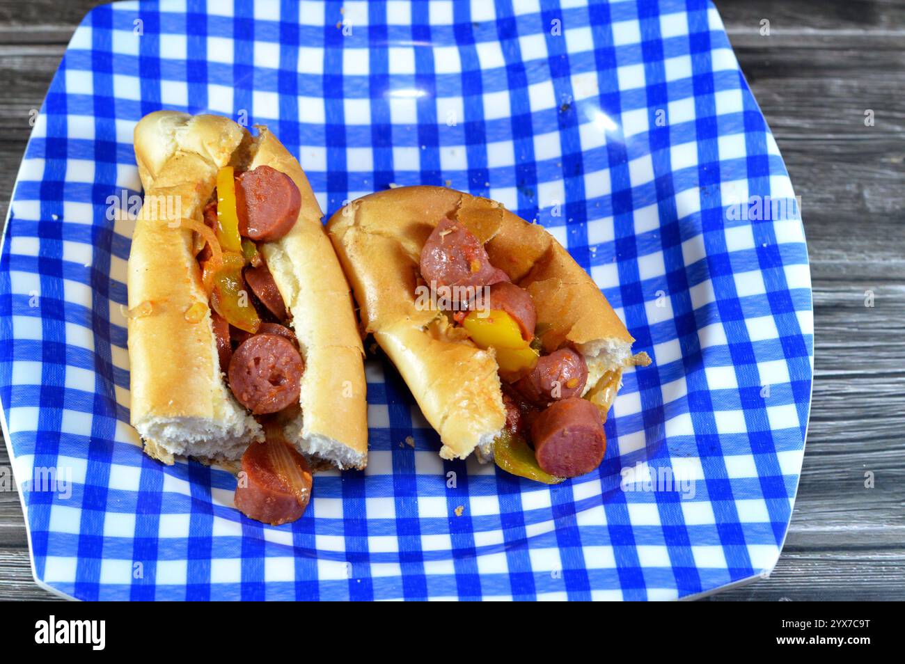 Partially sliced long bun with hot dog grilled beef sausage called ...