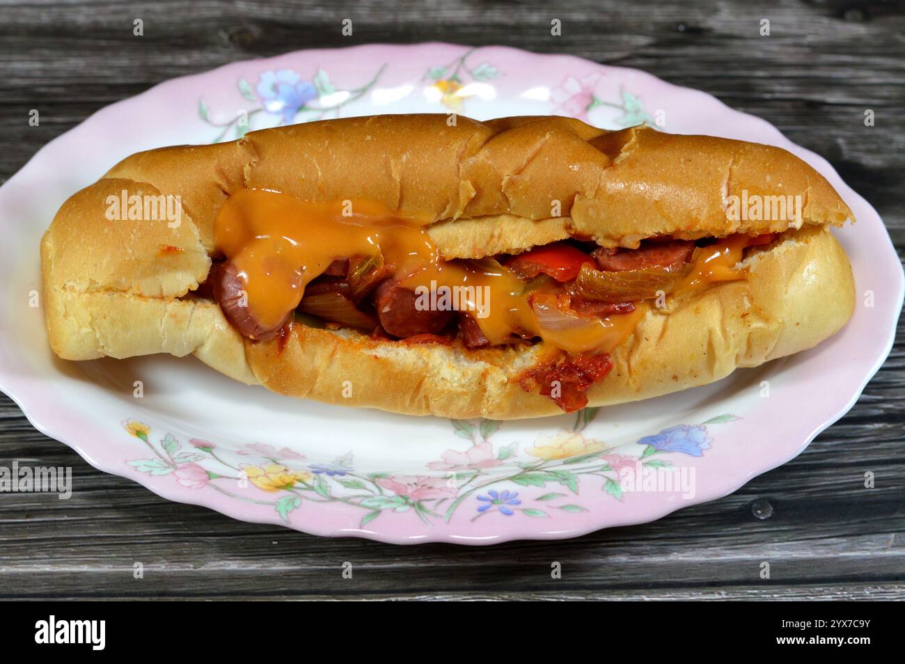 Partially sliced long bun with hot dog grilled beef sausage called ...