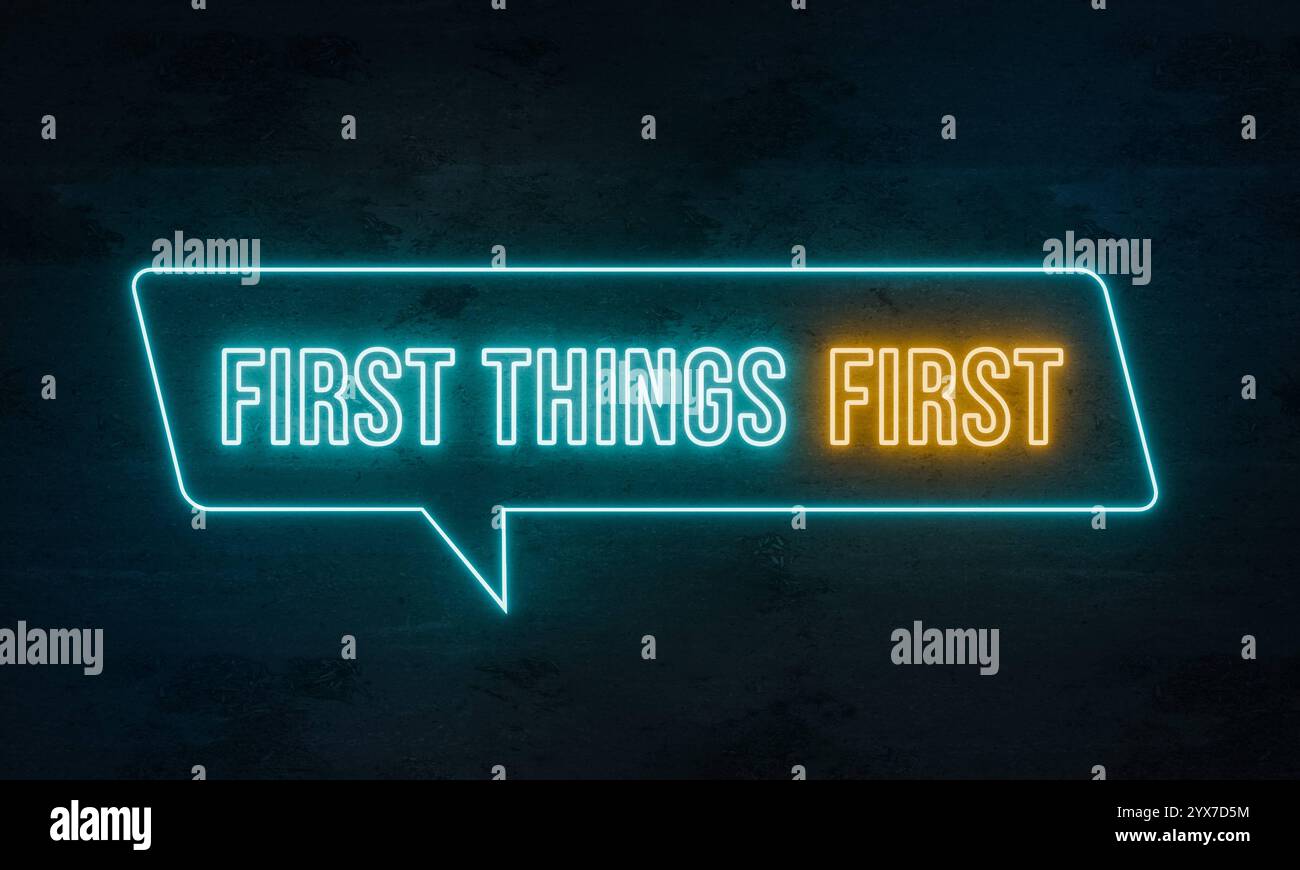 First things first. First things first. Illuminated neon sign in blue ...
