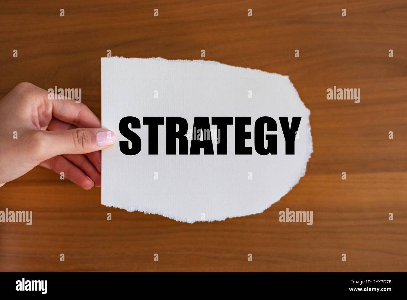 Strategy Strategy. Woman hand holds a piece of paper with a note ...