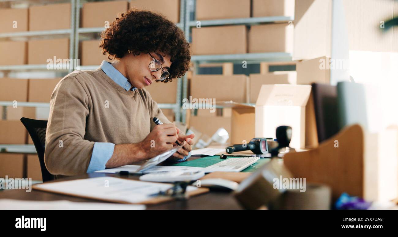 Man, writing and paperwork for distribution industry, inventory update ...