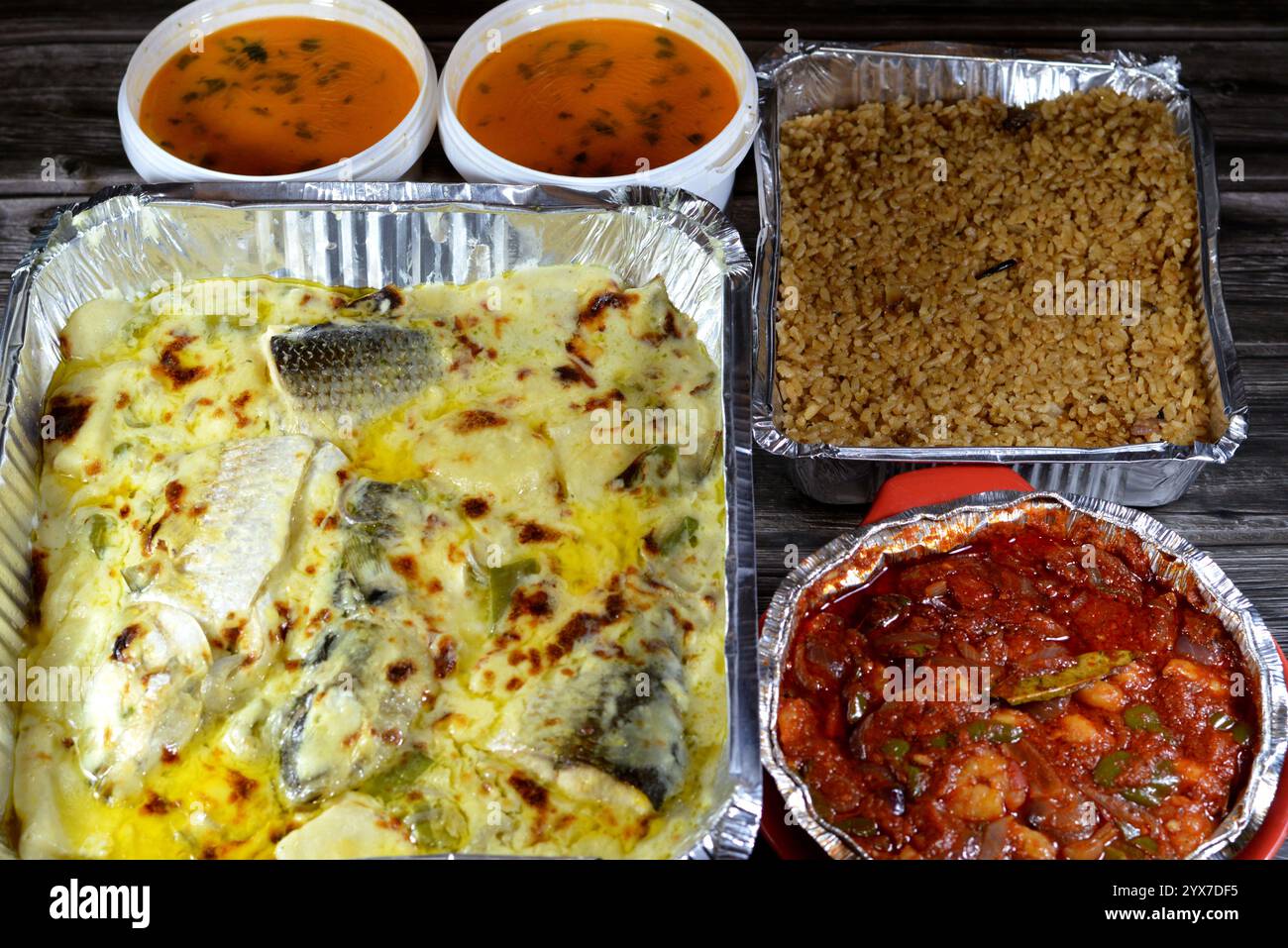 Seafood meal of baked mullet fishes with creamy white sauce, pieces of ...