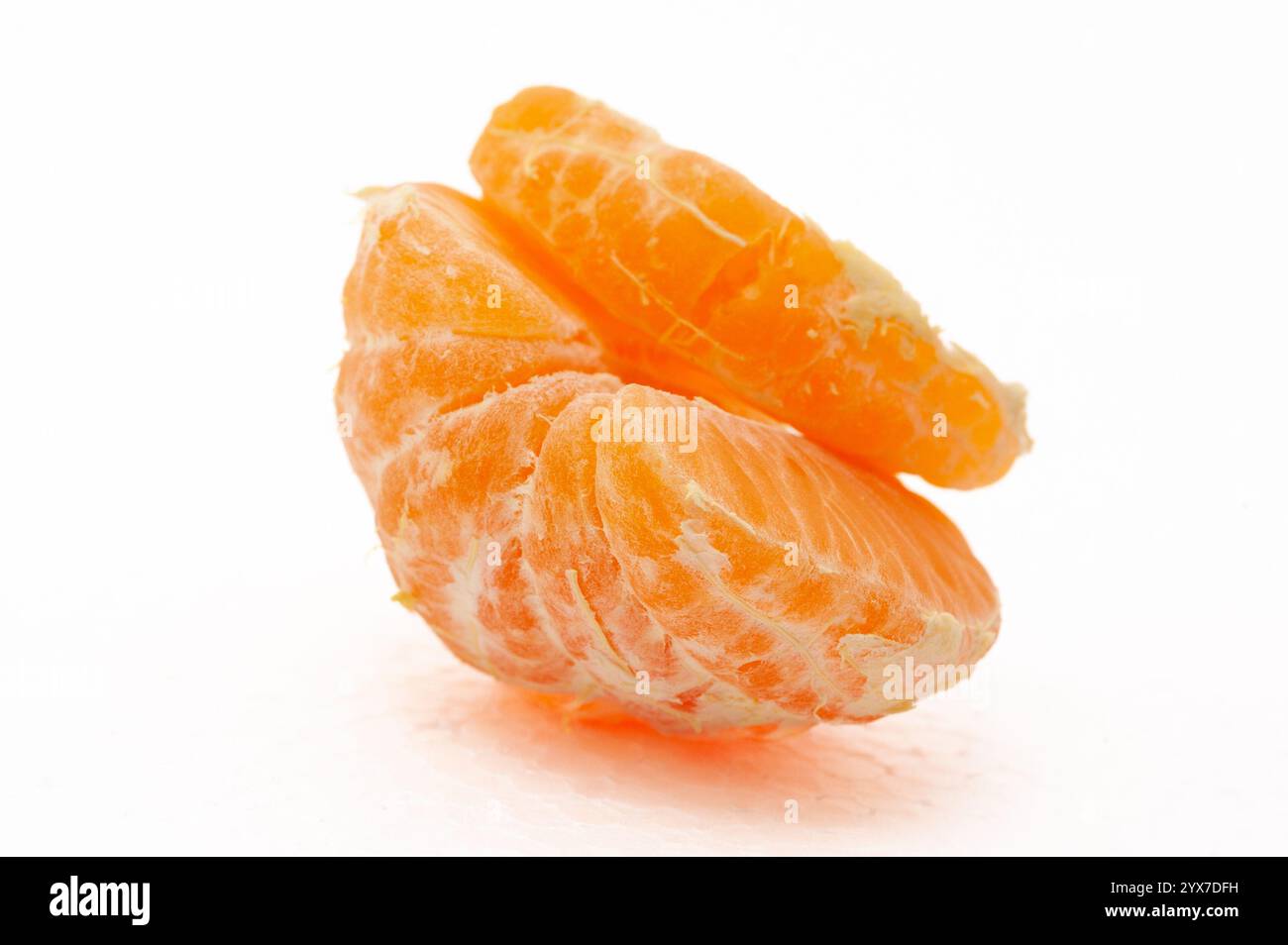 A slice of orange with a white stem. The orange mandarin is cut in half ...