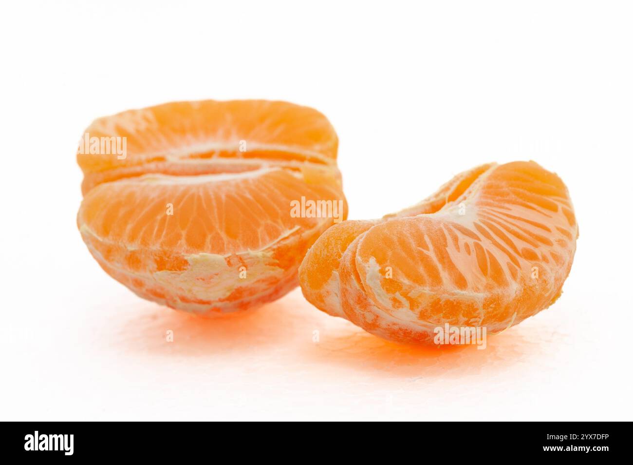 A small orange is cut in half. The inside of the orange mandarin and ...