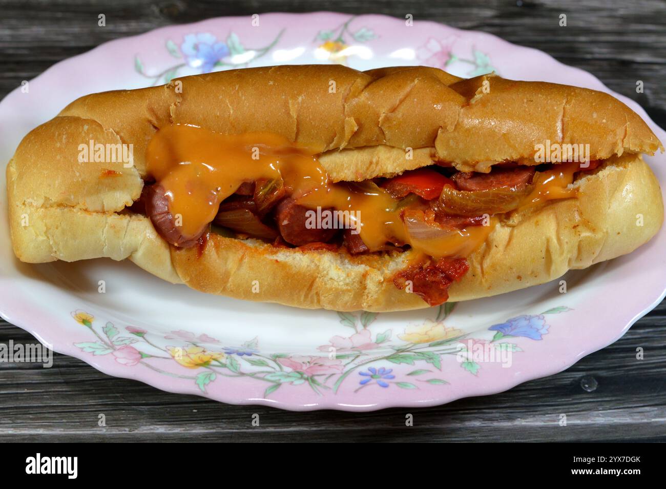 Partially sliced long bun with hot dog grilled beef sausage called ...