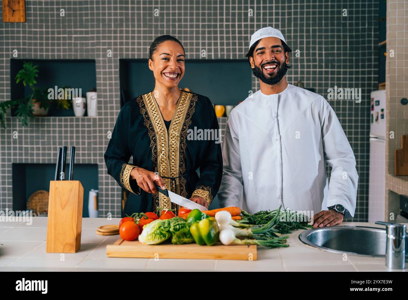 Happy beautiful young arab couple with emirati clothing together at home - Middle-eastern man ...