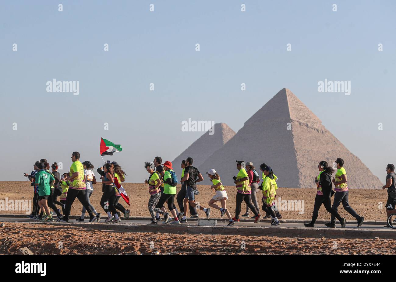 Giza, Egypt. 14th Dec, 2024. Contestants run during the Pyramids Half ...