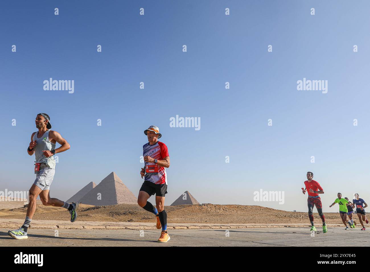Giza, Egypt. 14th Dec, 2024. Contestants run during the Pyramids Half ...