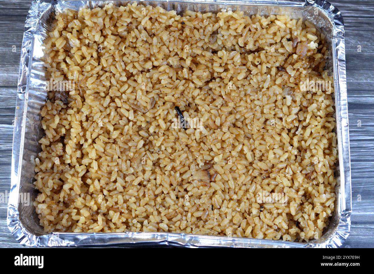 Cooked white Egyptian rice by hot steam and gained the brown color from ...