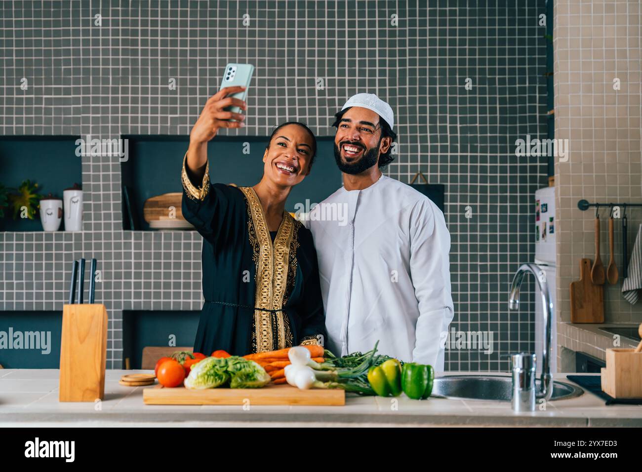 Happy beautiful young arab couple with emirati clothing together at ...