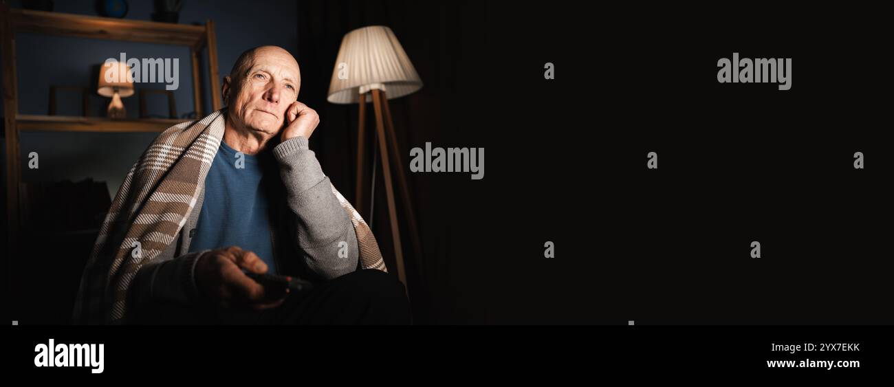 Bored pensioner retired wrapped in blanket watching movie alone at home ...