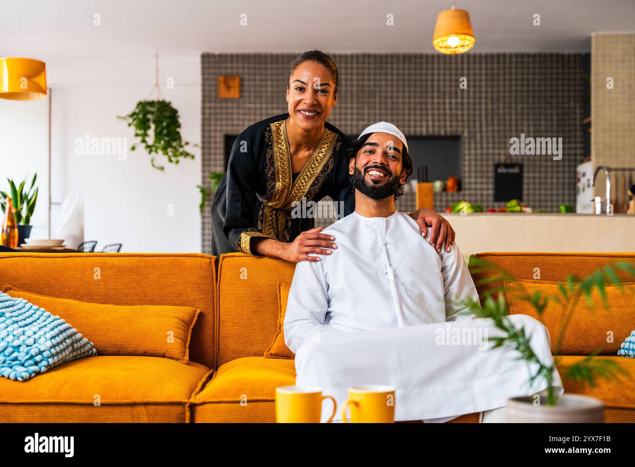 Happy beautiful young arab couple with emirati clothing together at home - Middle-eastern man ...