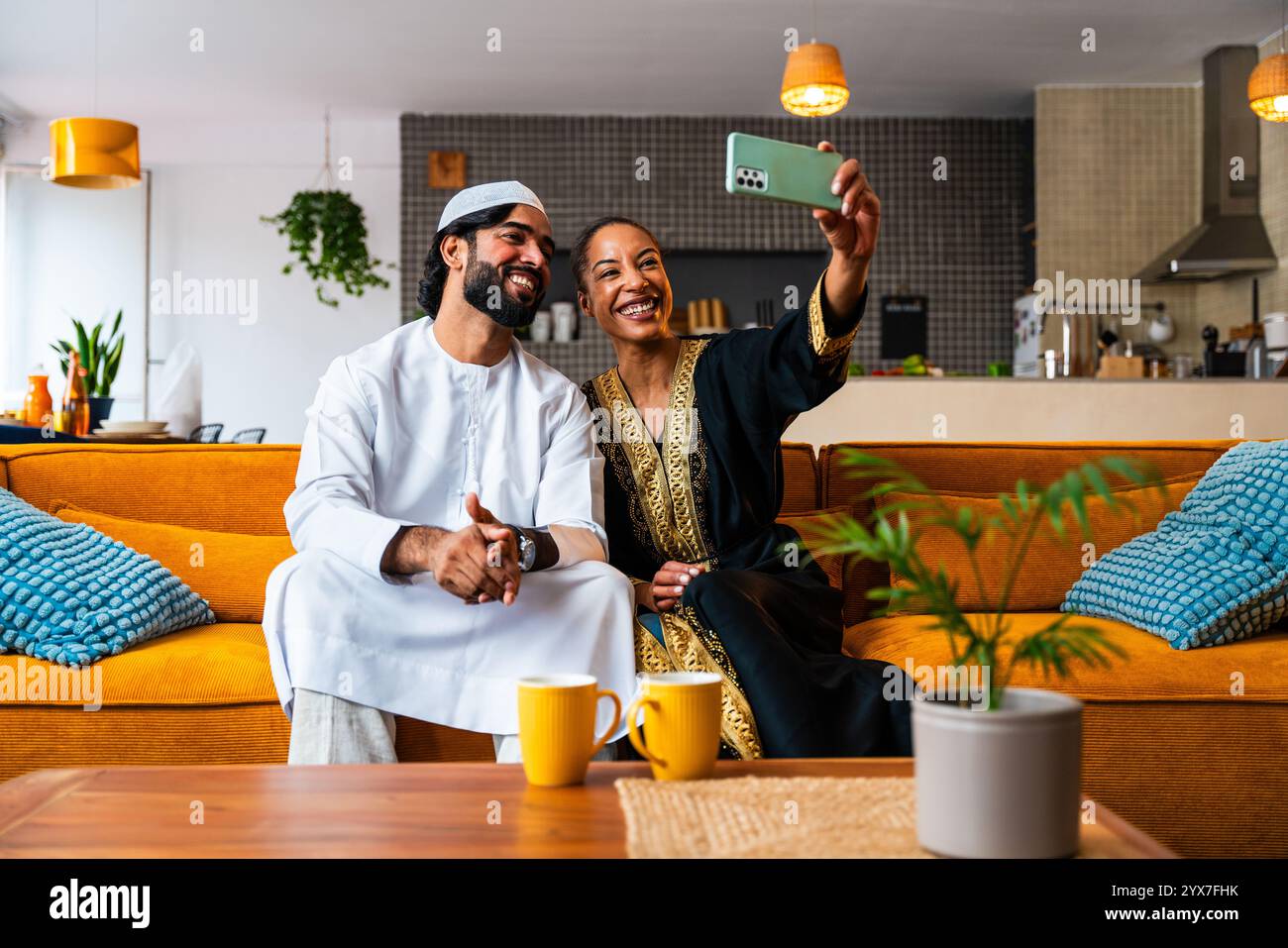 Happy beautiful young arab couple with emirati clothing together at ...