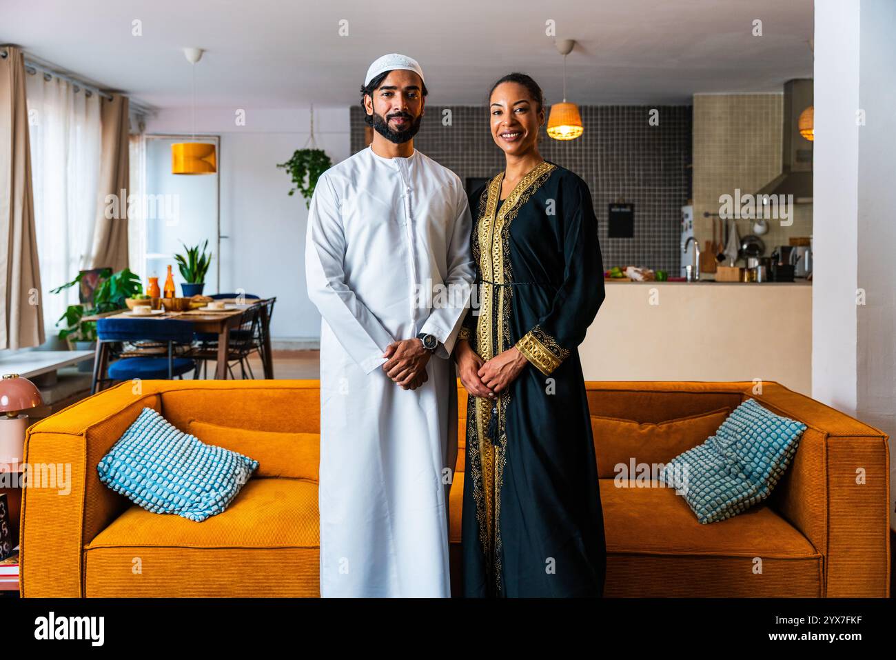 Happy beautiful young arab couple with emirati clothing together at home - Middle-eastern man ...