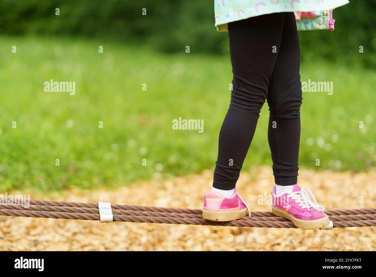Children's legs balance on a rope. Children's feet in shoes close-up ...