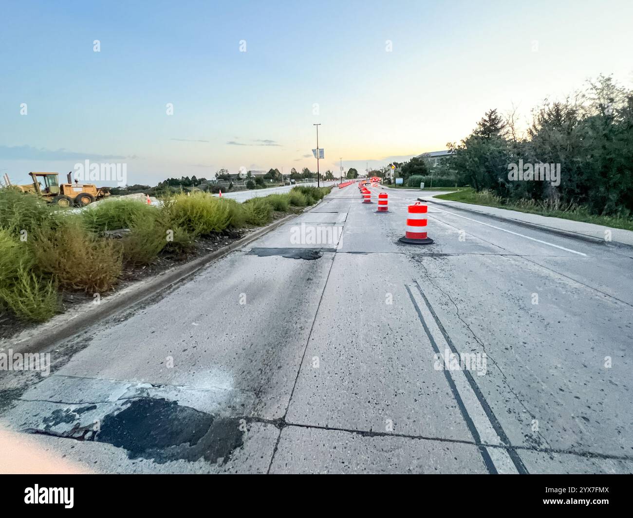 Road Construction Zone with Traffic Barrels at Sunrise Stock Photo - Alamy