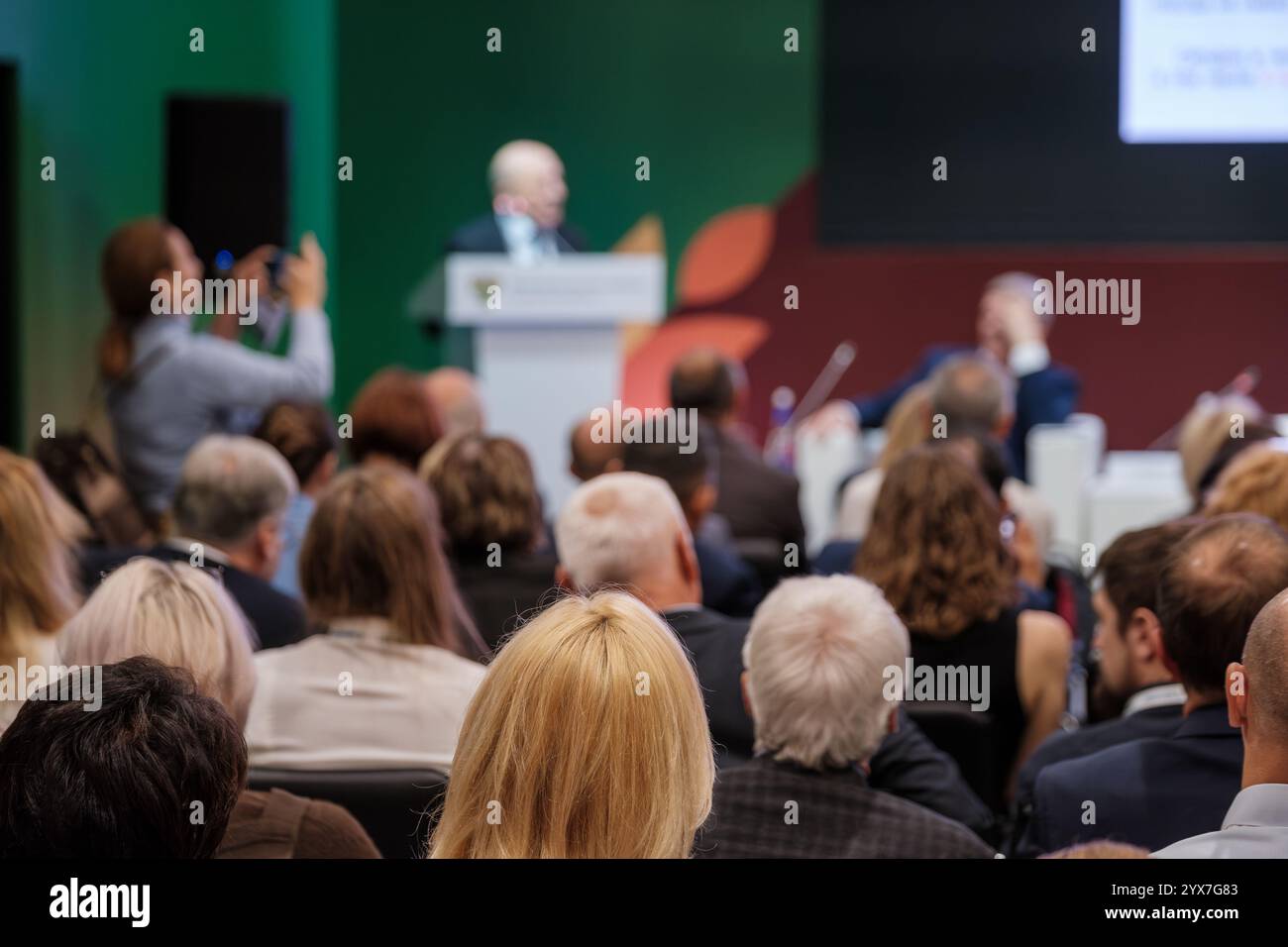 Large audience attending a professional seminar in an auditorium ...