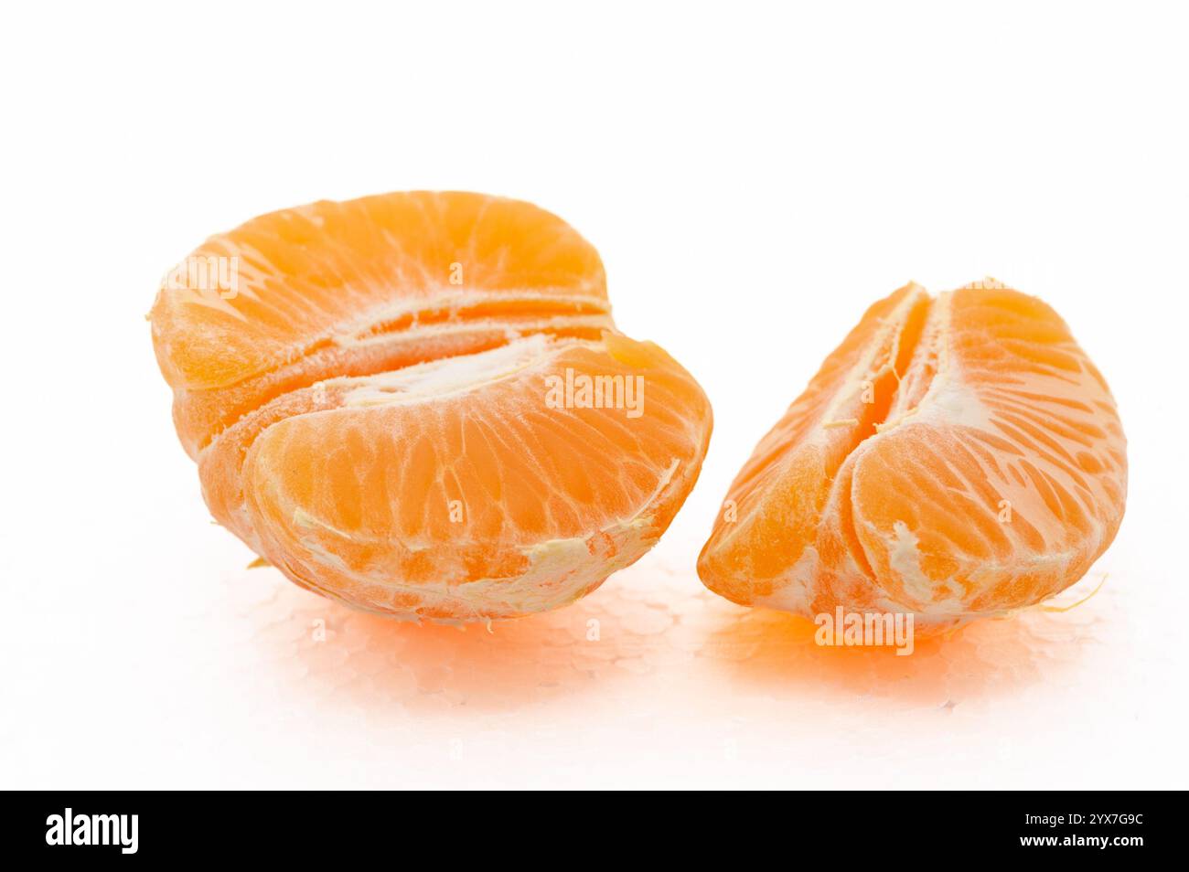 A small orange is cut in half. The inside of the orange mandarin and ...